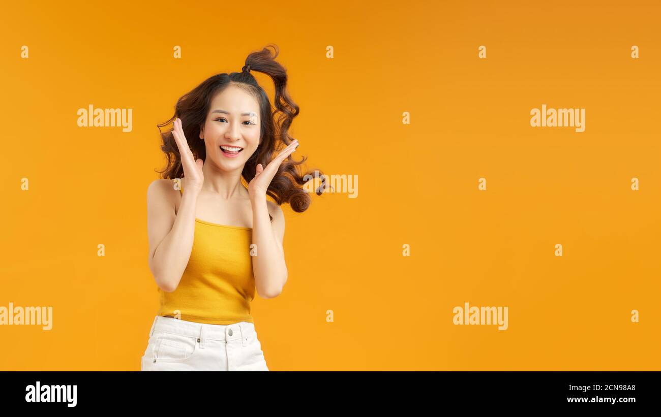 Young and beautiful cute Asian girl jumping high with feel exiting face ...