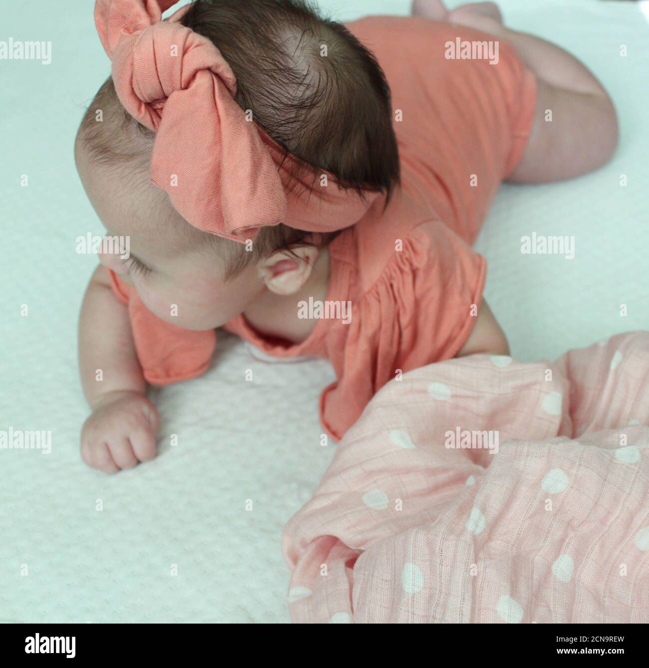 A baby learning to crawl Stock Photo - Alamy