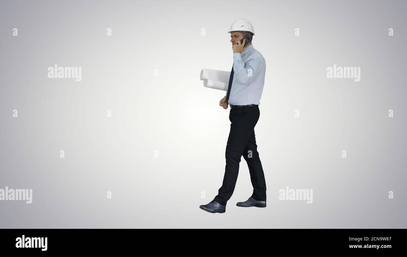 Engineer talking on phone with paperwork on gradient background Stock ...