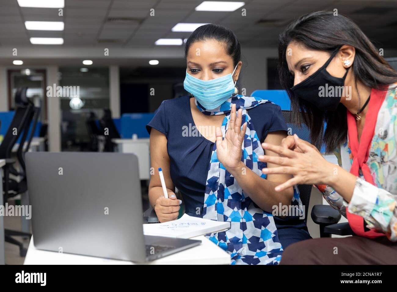 Portrait of a two Indian businesswomen having a meeting, project ...