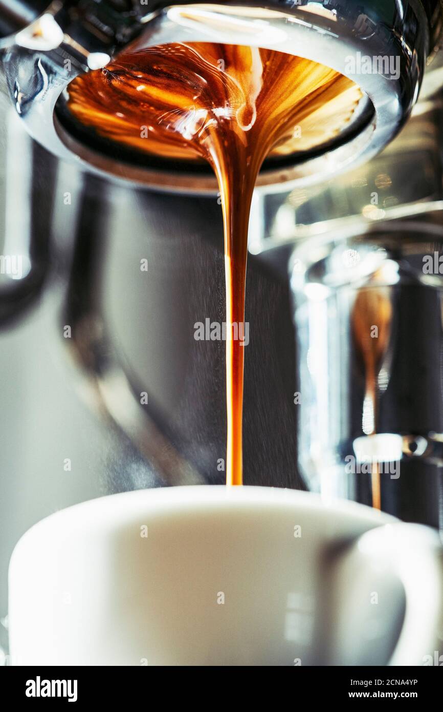 Close up espresso dripping into coffee cup Stock Photo - Alamy
