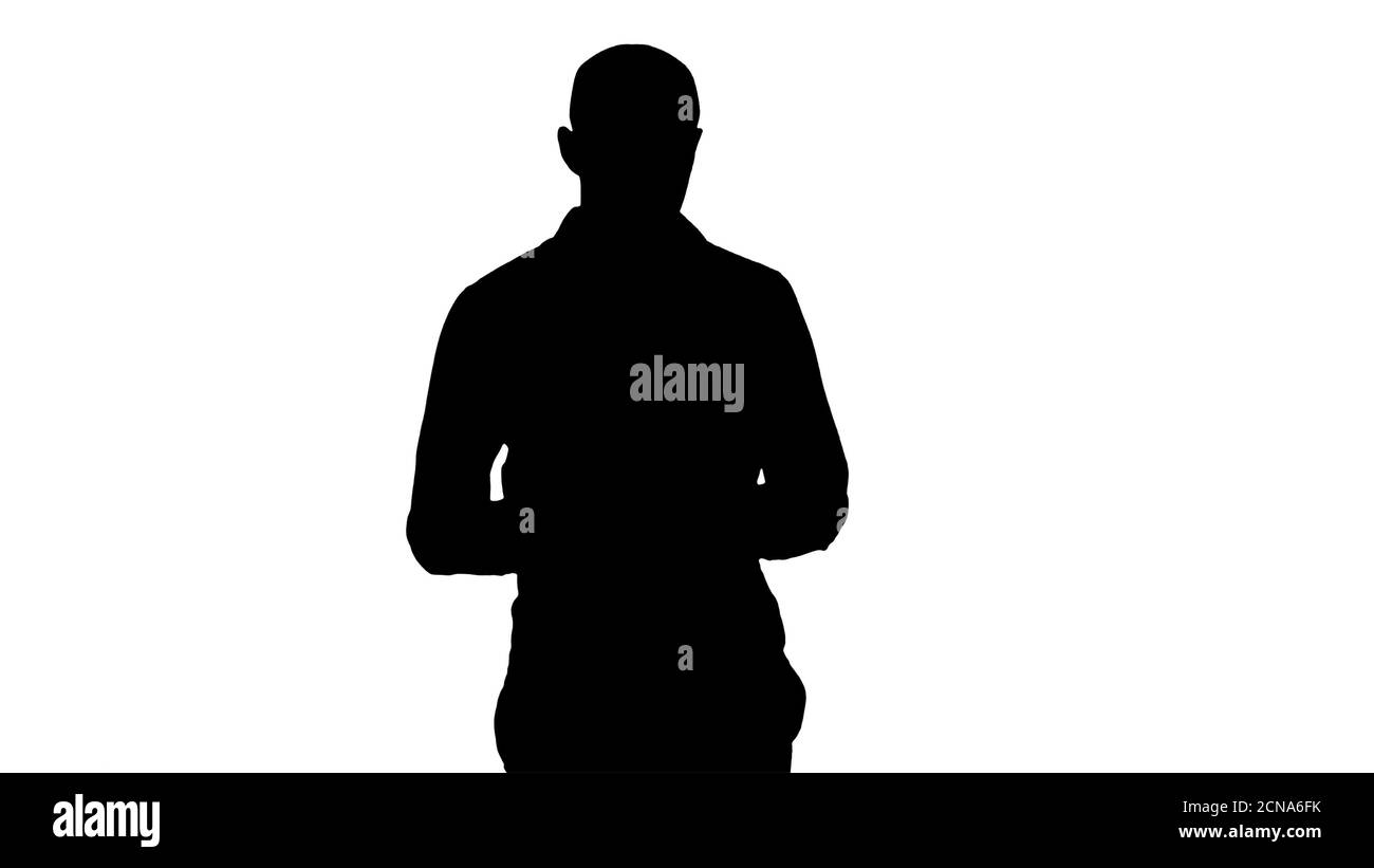 Silhouette Man text messaging while walking Stock Photo - Alamy