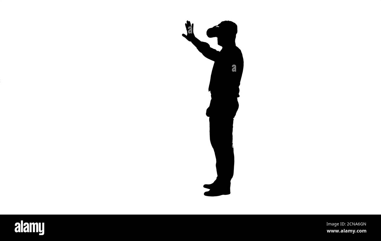 Silhouette Young businessman using vr headset Stock Photo - Alamy