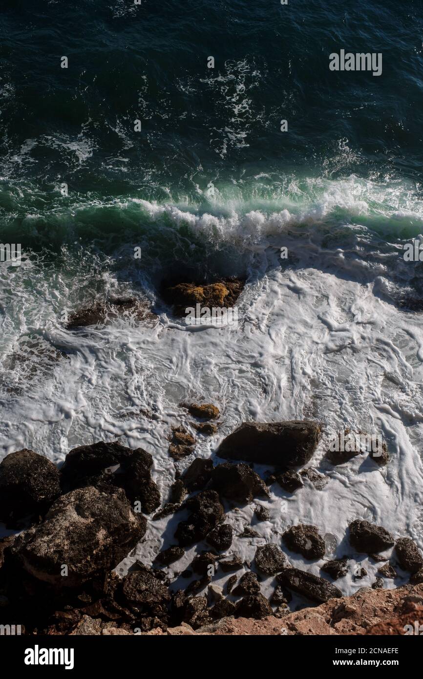 Ocean wave background breaking sea water rocky shore rough seas ...