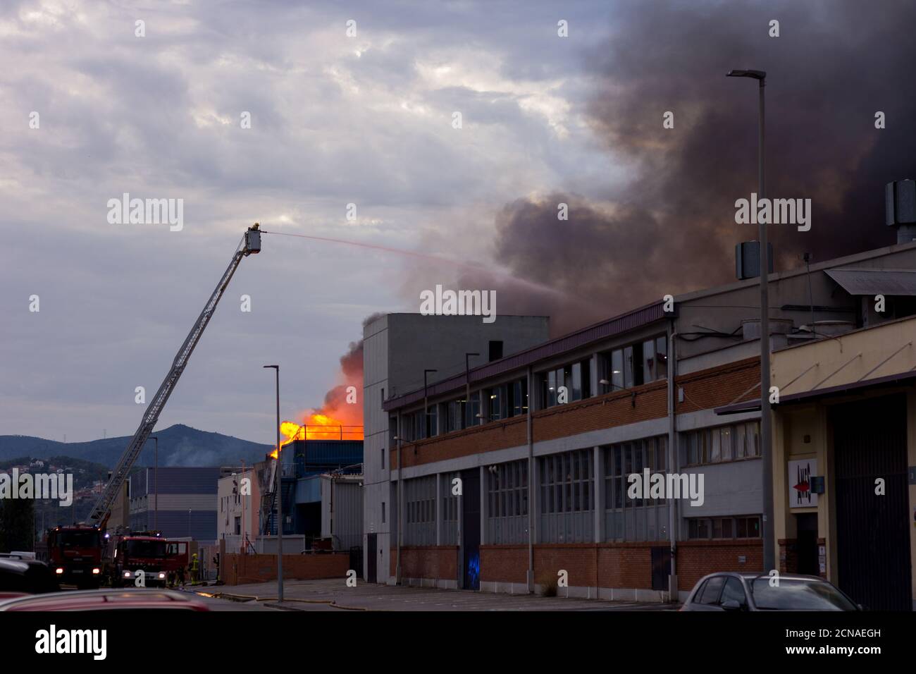 Firefighters, police, toilets, ambulances in a factory fire. Fire ...