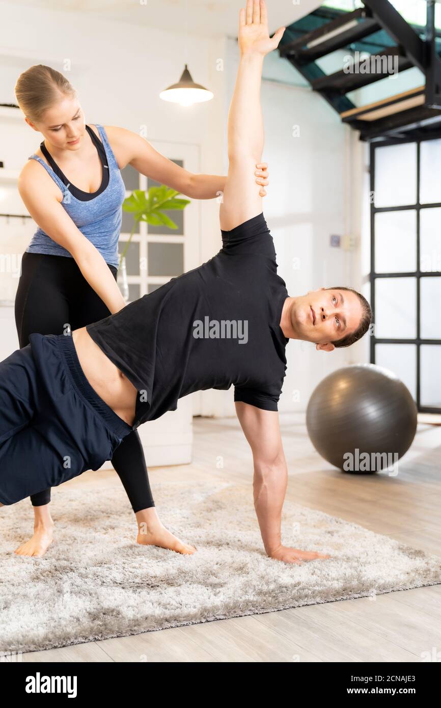 Yoga training at home with personal trainer Stock Photo - Alamy