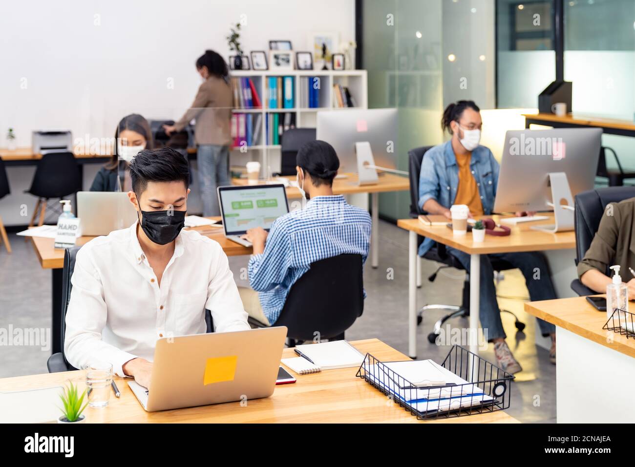 Social distance office with business team wear face mask as new normal ...