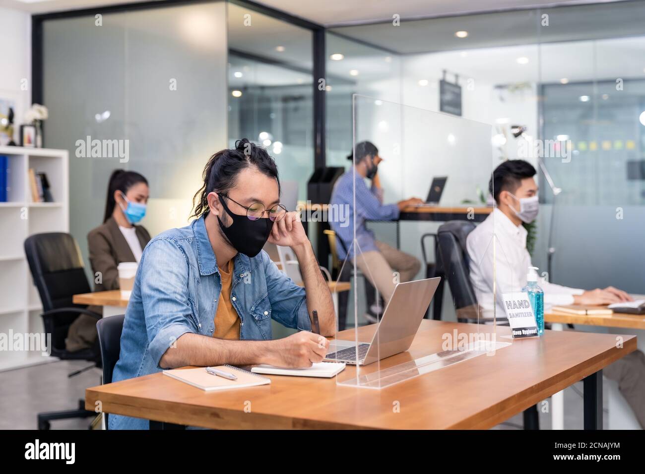 Social distance office with business team wear face mask as new normal ...