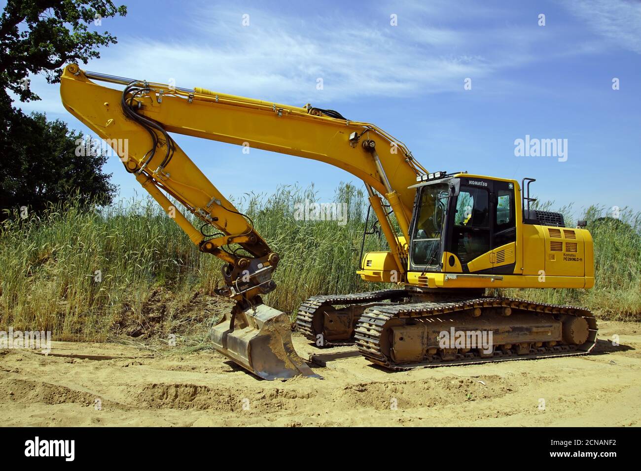 Excavator working in a rural field Stock Photo - Alamy