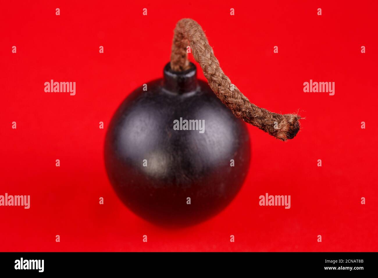 cannonball on red background Stock Photo - Alamy