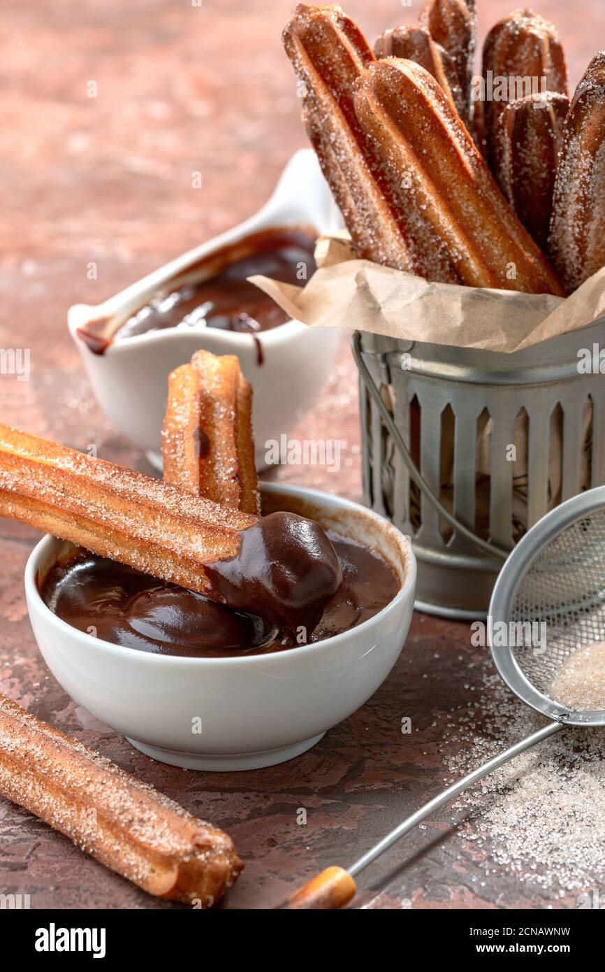 Traditional churros sticks with cinnamon and chocolate Stock Photo - Alamy