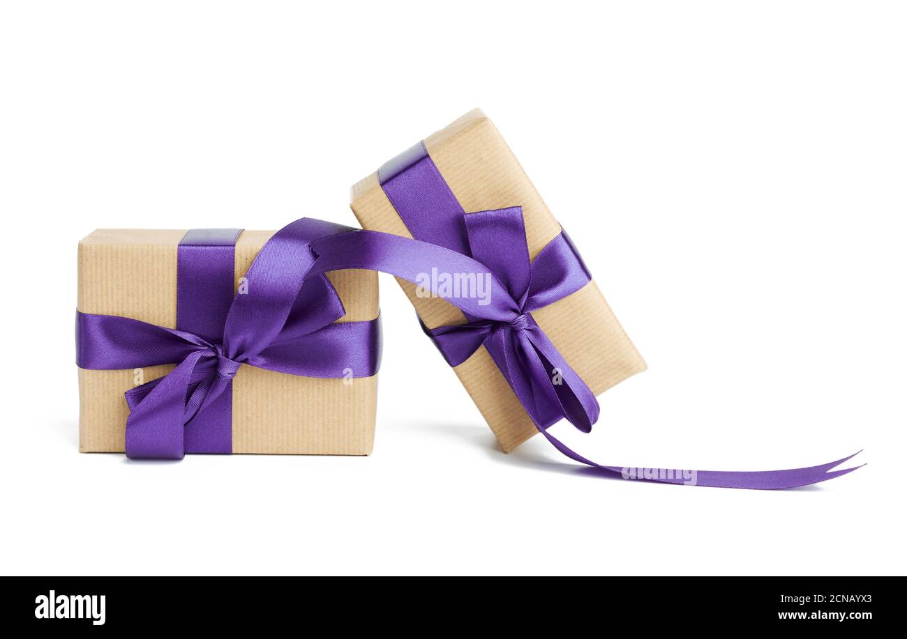 stack of wrapped boxes in brown kraft paper and tied with silk purple ...