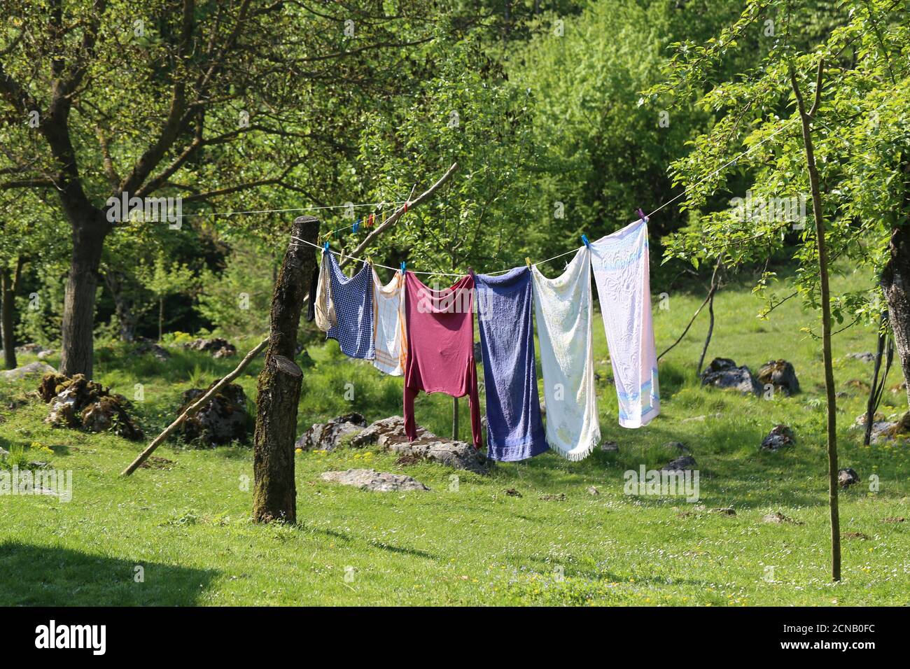 Laundry hanging on a rope and drying in the backyard of a house Stock ...