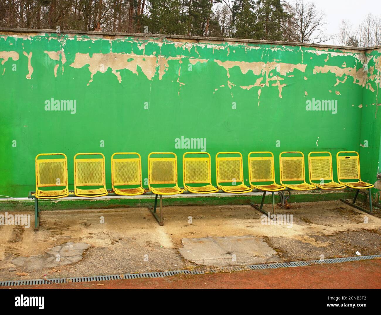 Vintage steel seats on outdoor stadium players bench chairs with worn ...