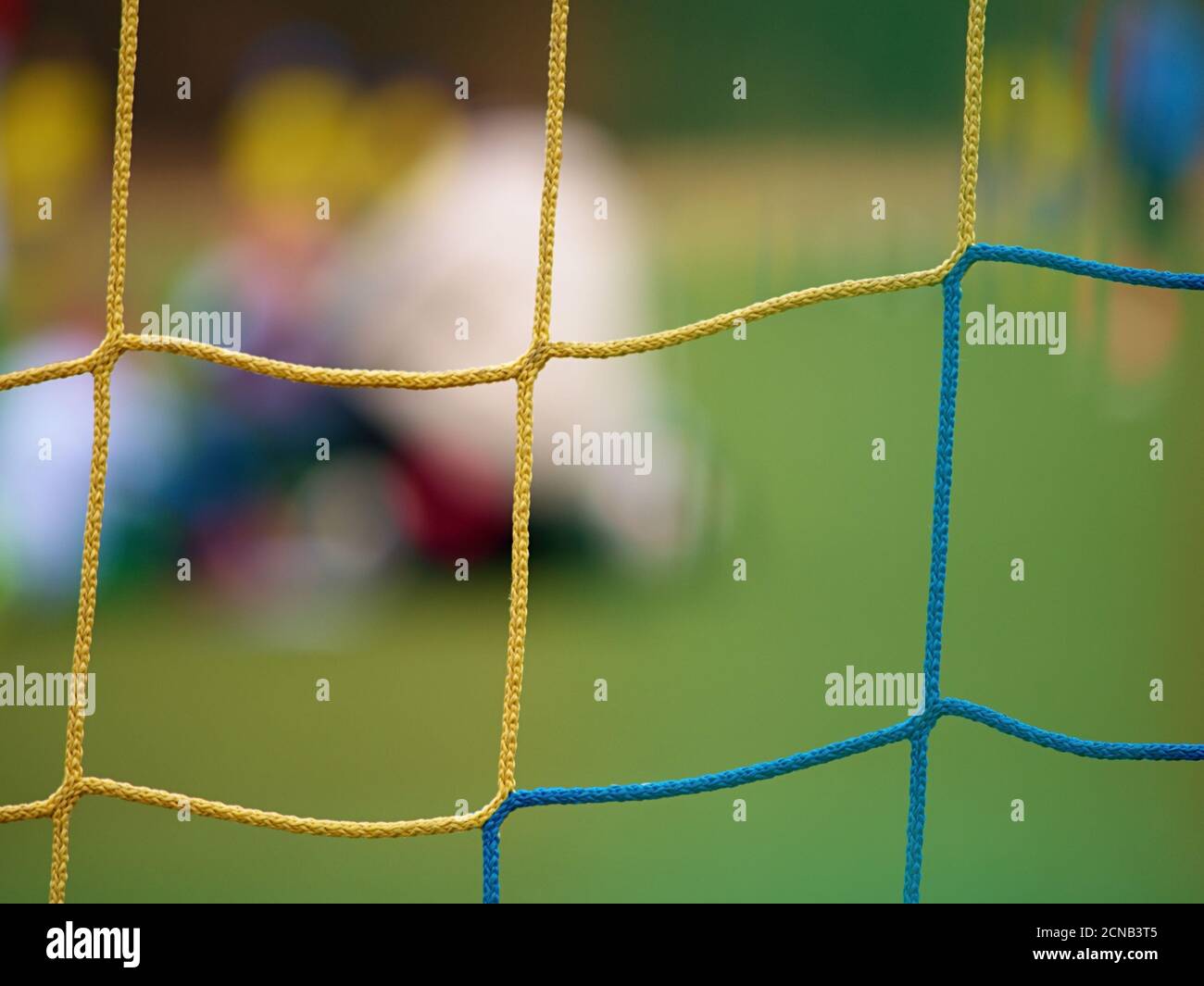 Football player stands against goal with net and stadium. Football gate ...