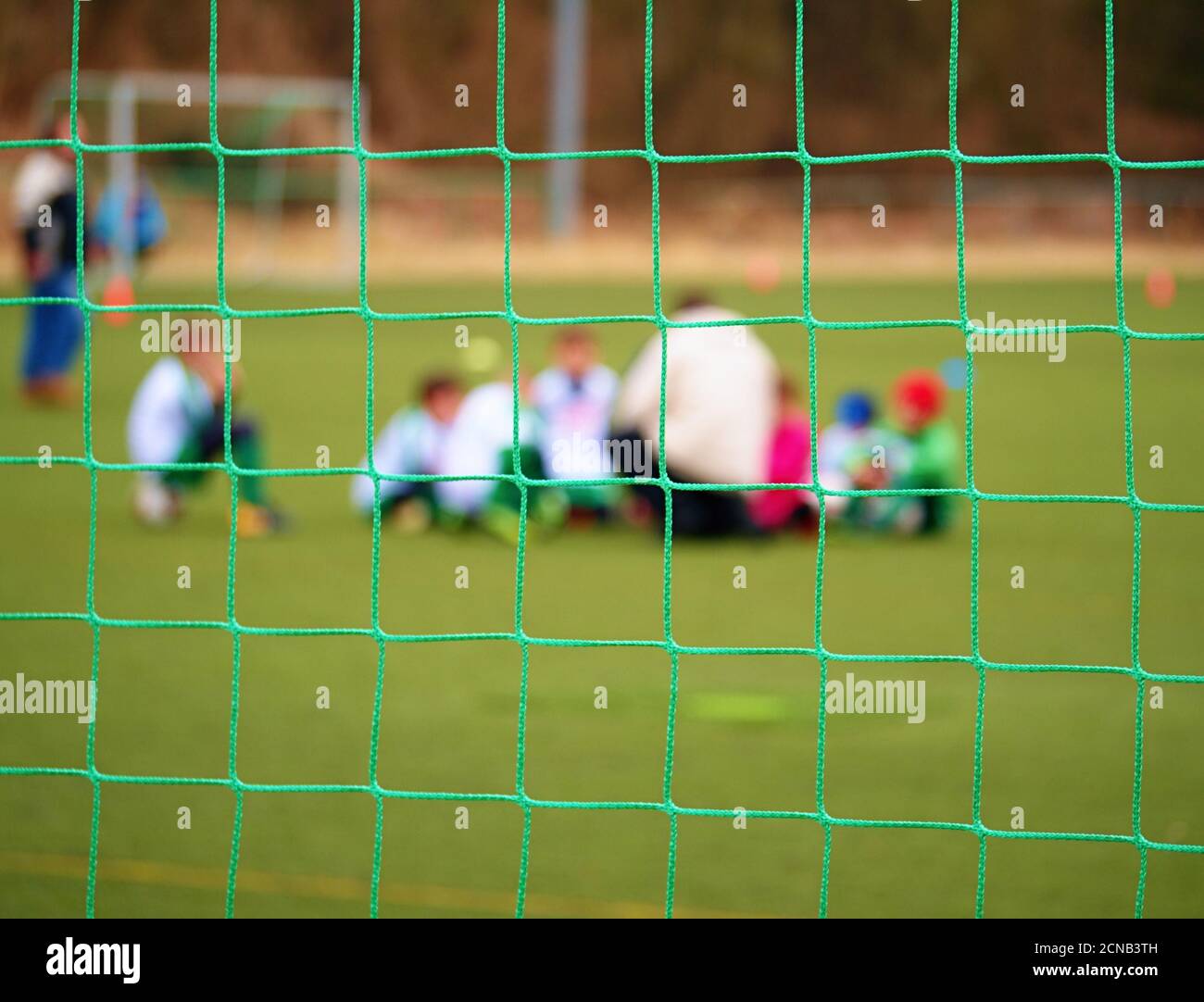 Football gate net. Soccer gate net. In blurry background stand players ...