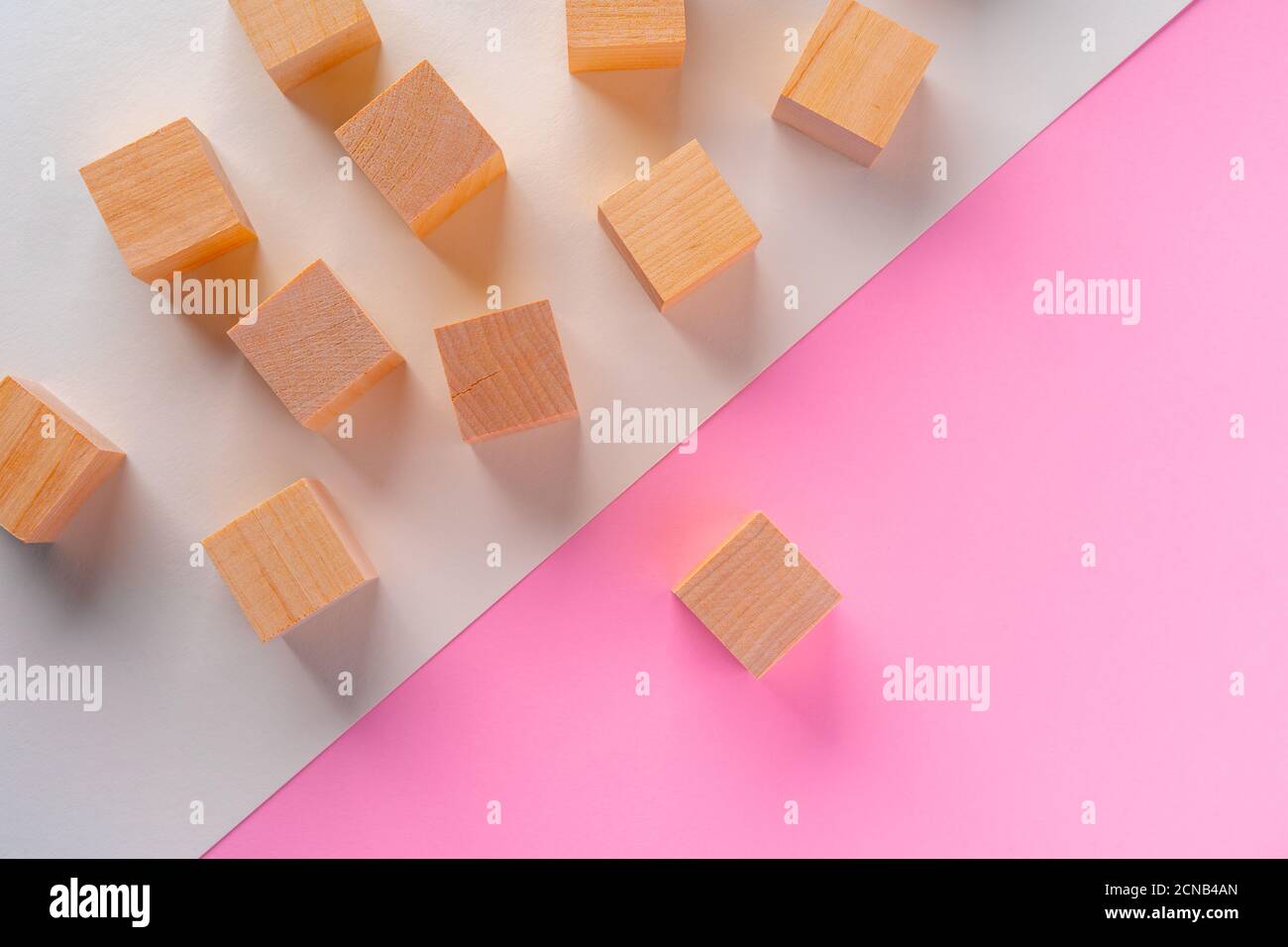 Wooden square block on pink and white background Stock Photo - Alamy