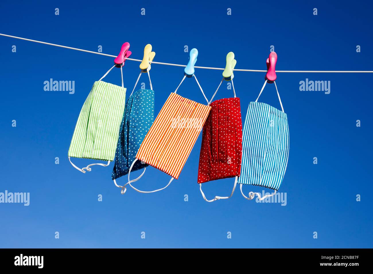colourful face masks hanging on a washing line Stock Photo - Alamy
