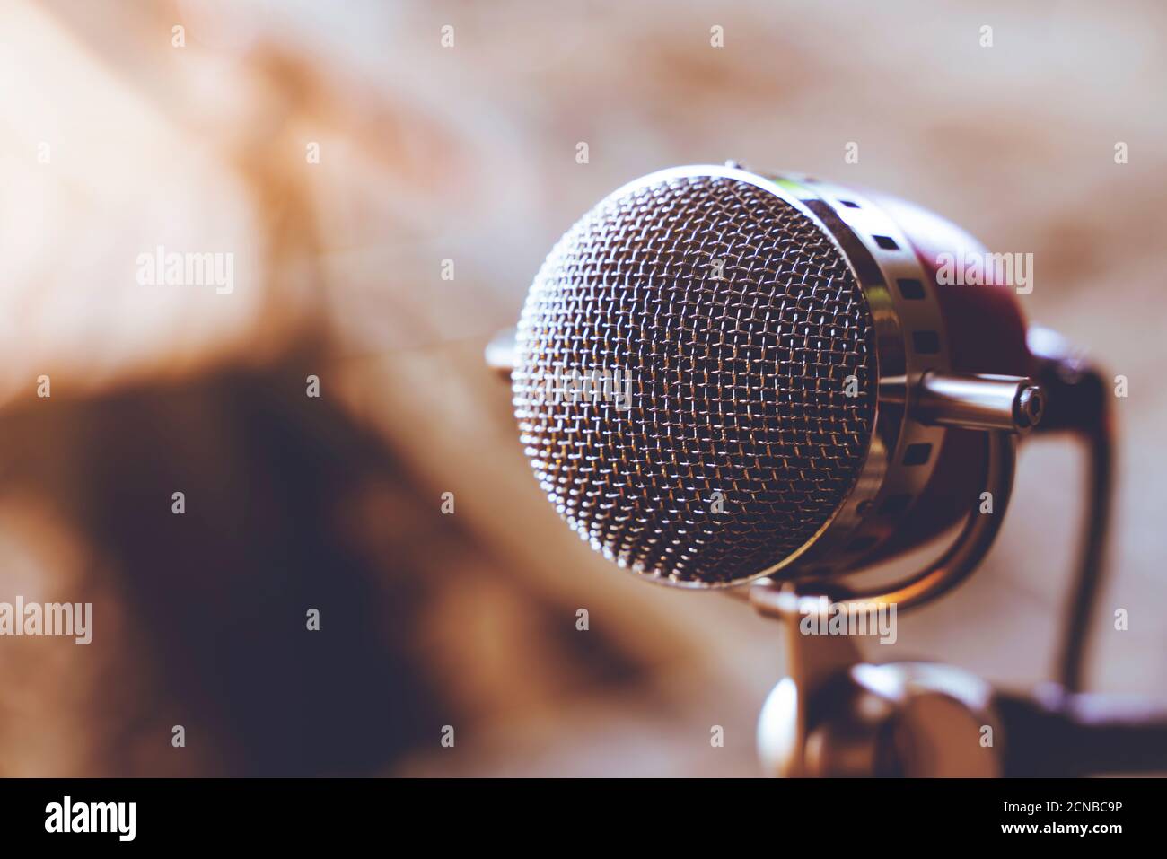 Retro microphone against blur sun light background Stock Photo - Alamy