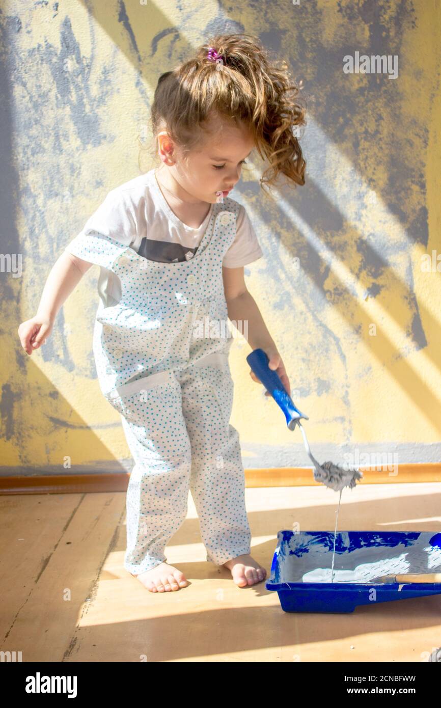 Little kid girl helping making renovation at house room Stock Photo - Alamy