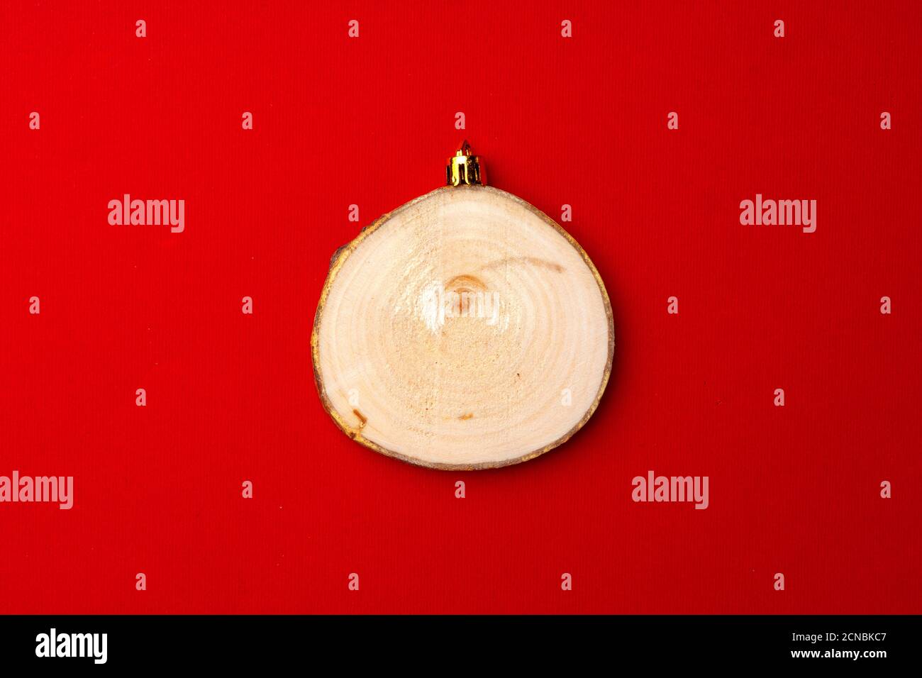 Christmas toy made of cross section of the tree on red Stock Photo - Alamy