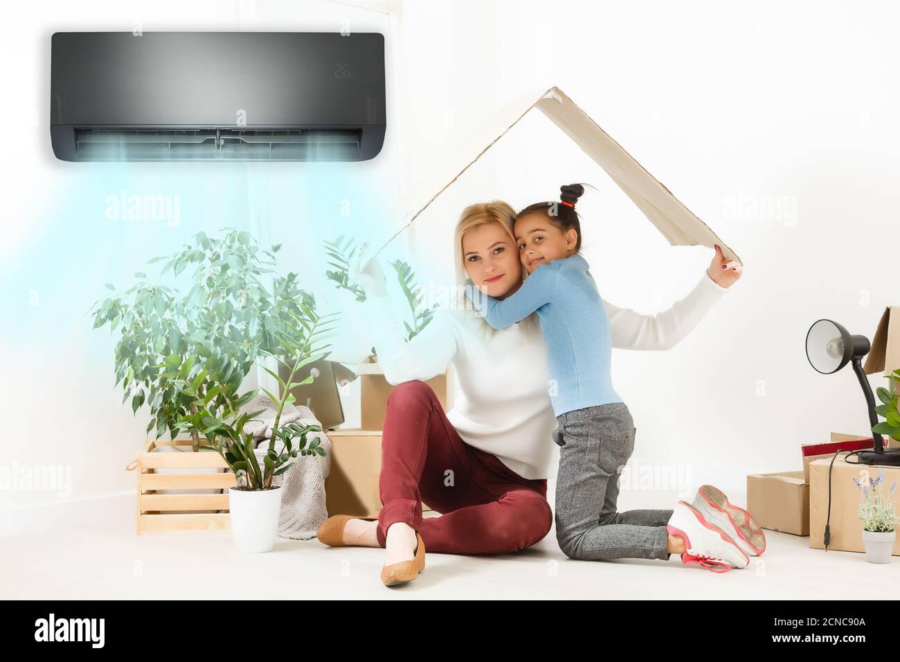 air conditioning in living room with happy family moving to new ...