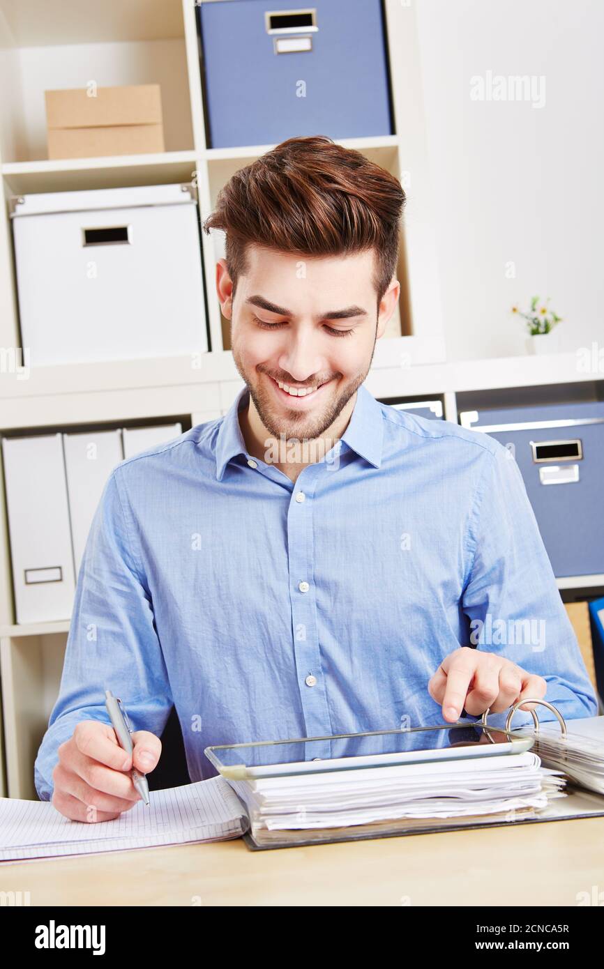 Laughing man in the office uses tablet computer to work Stock Photo - Alamy