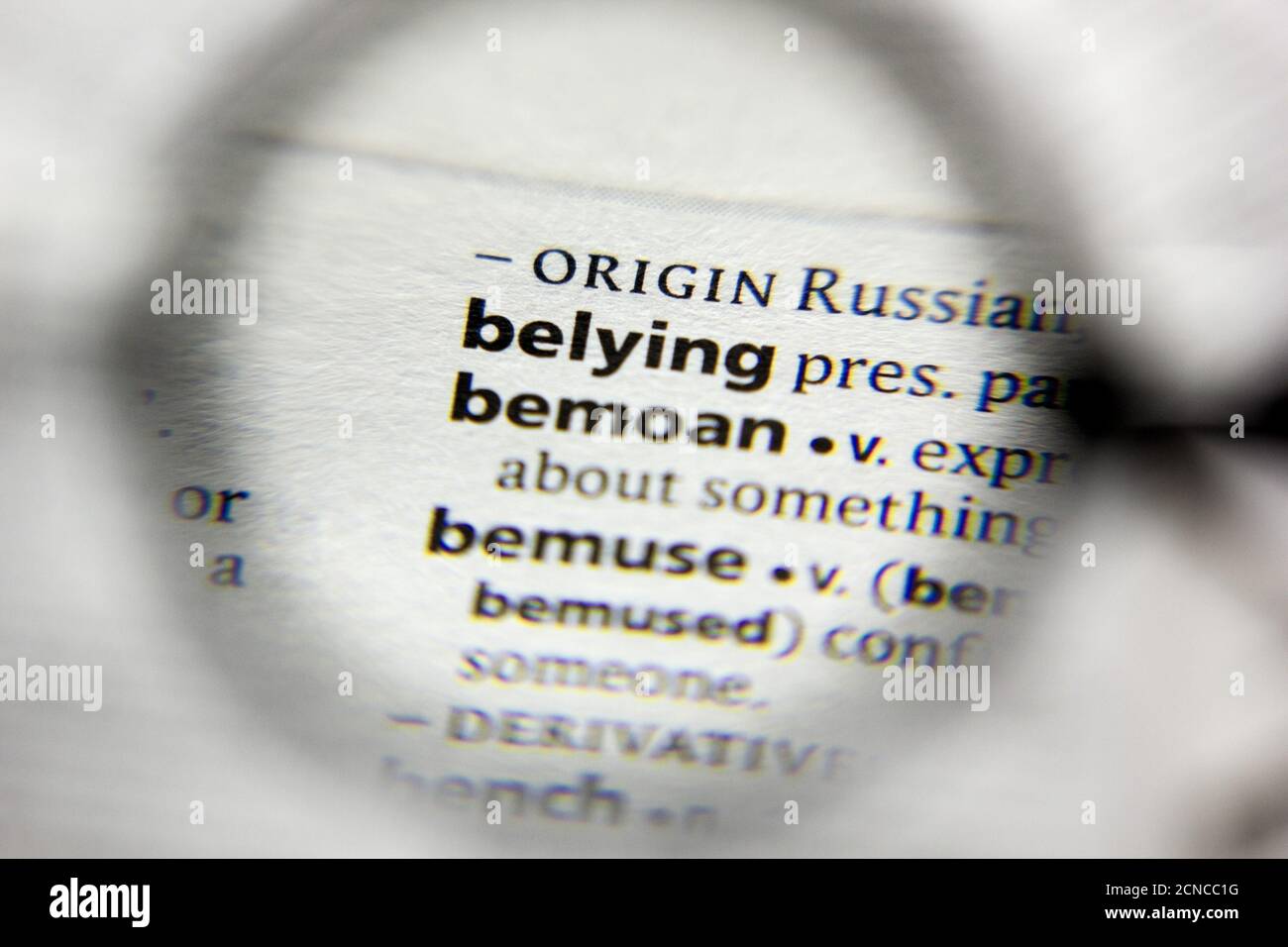 The word or phrase belying in a dictionary Stock Photo - Alamy