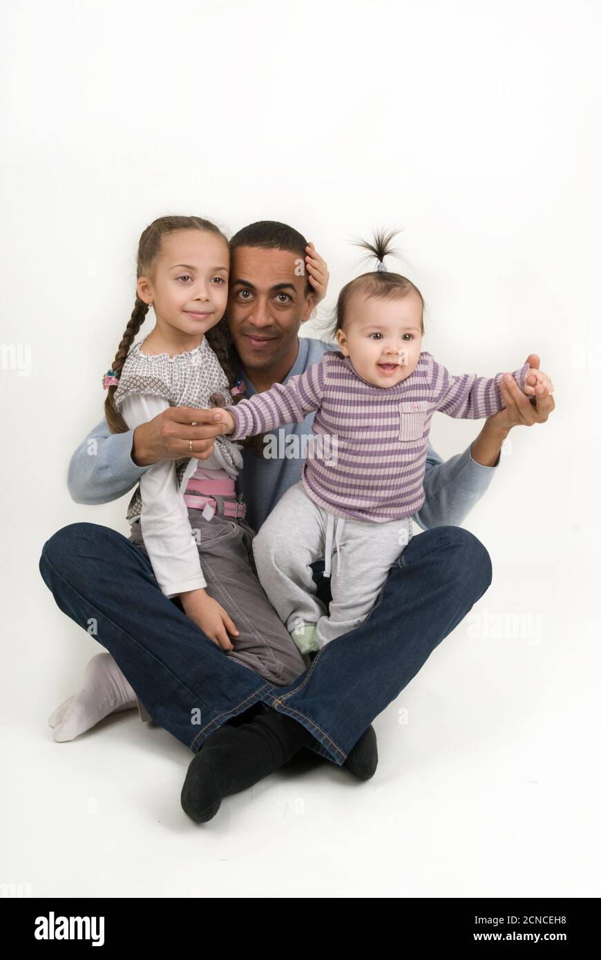 Multiracial family. Dad with two daughters Stock Photo - Alamy