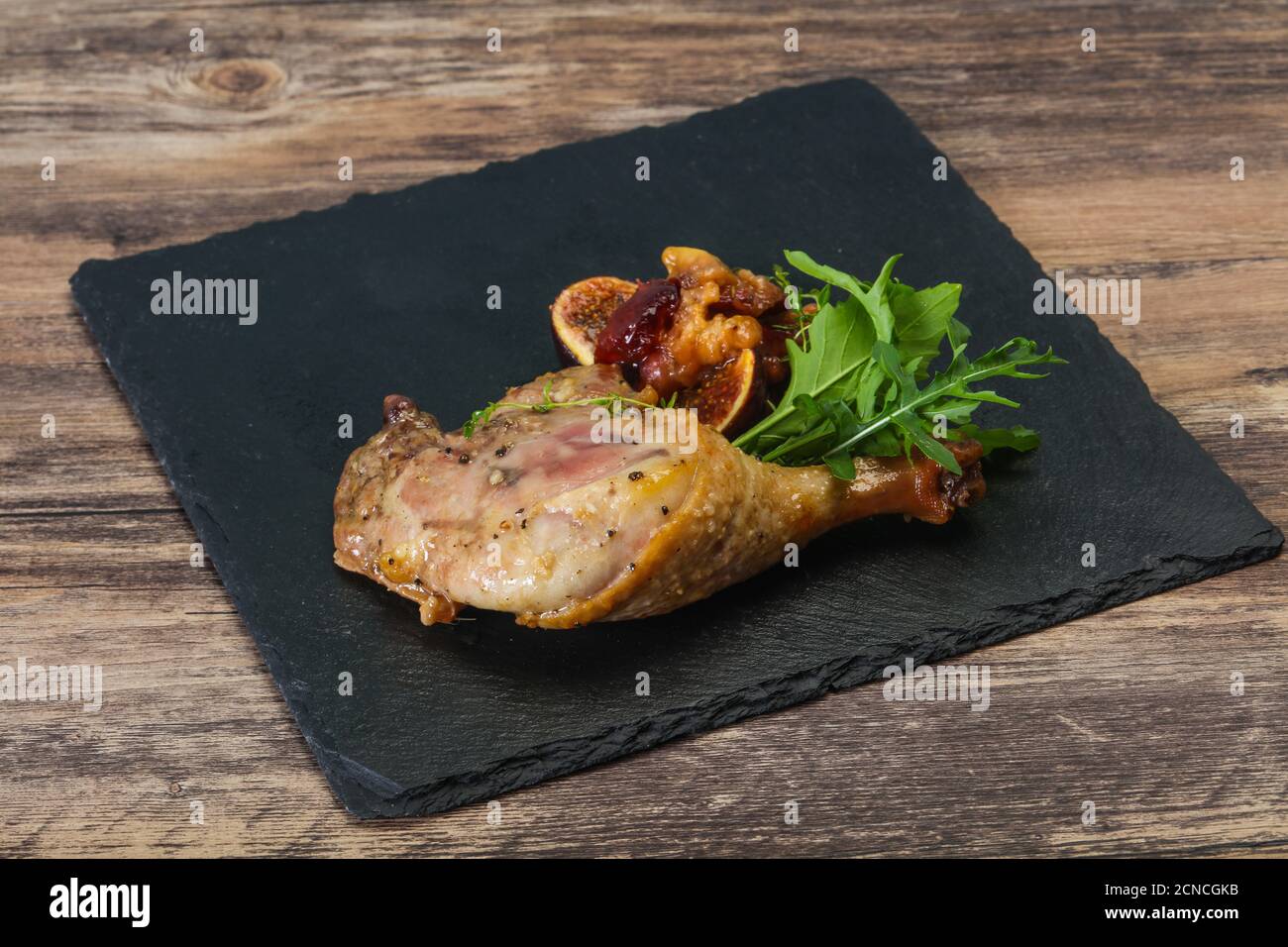 Roasted. duck. leg with plum, fig and apple Stock Photo - Alamy