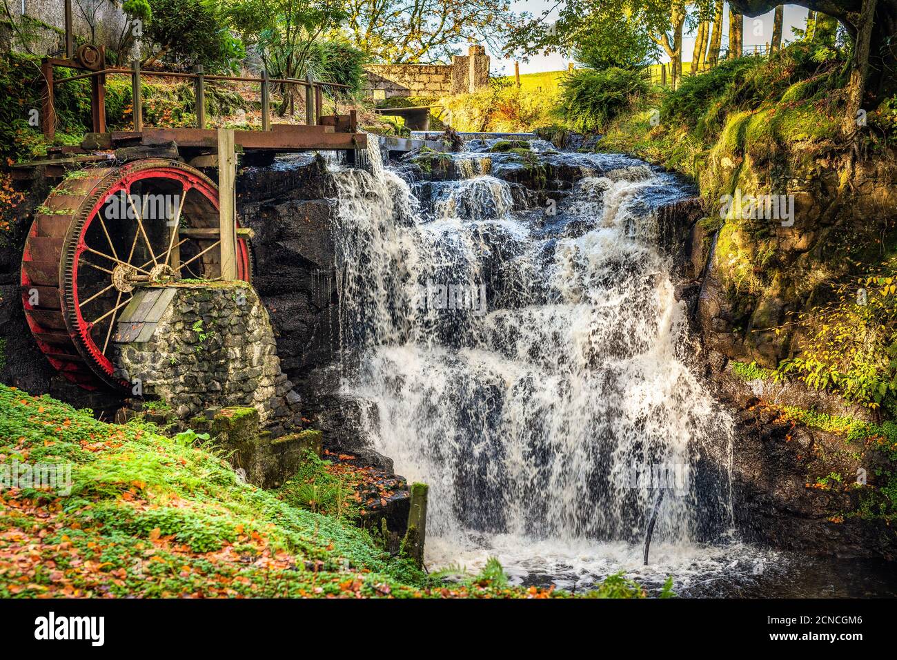 Vintage red waterwheel with waterfall in Glenariff Forest Park Stock ...