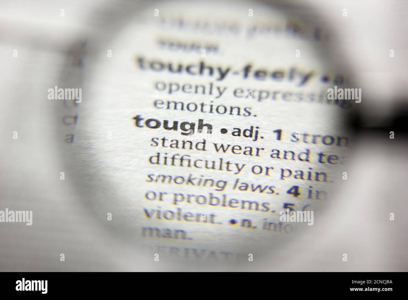The word or phrase Tough in a dictionary Stock Photo - Alamy