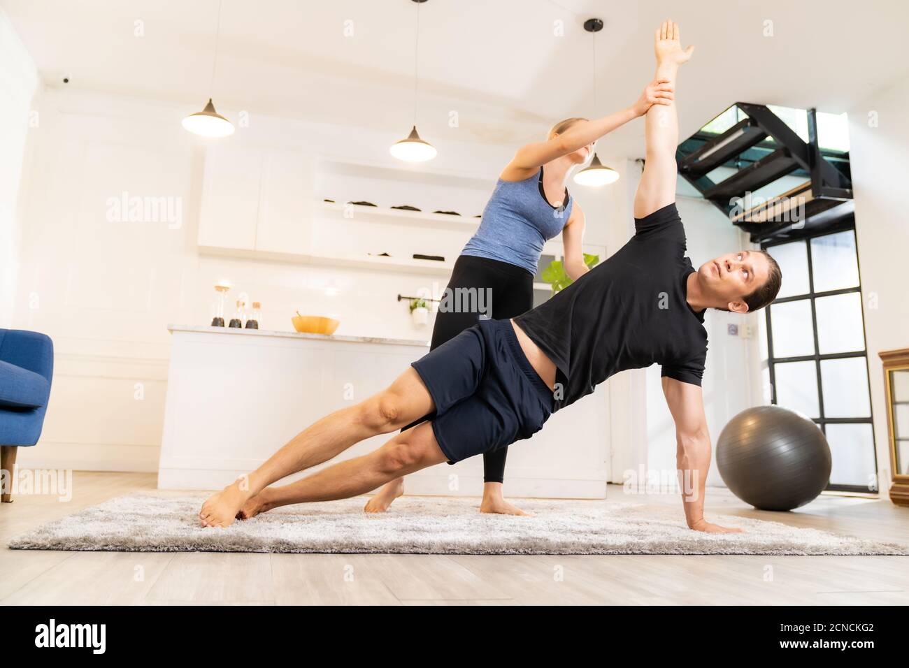 Yoga training at home with personal trainer Stock Photo - Alamy