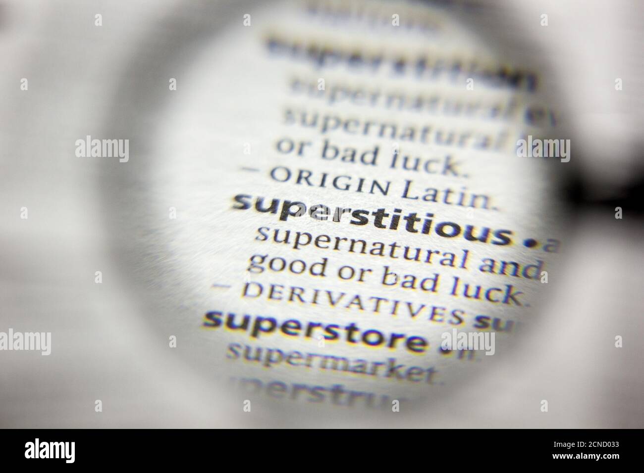 The word or phrase Superstitious in a dictionary Stock Photo - Alamy