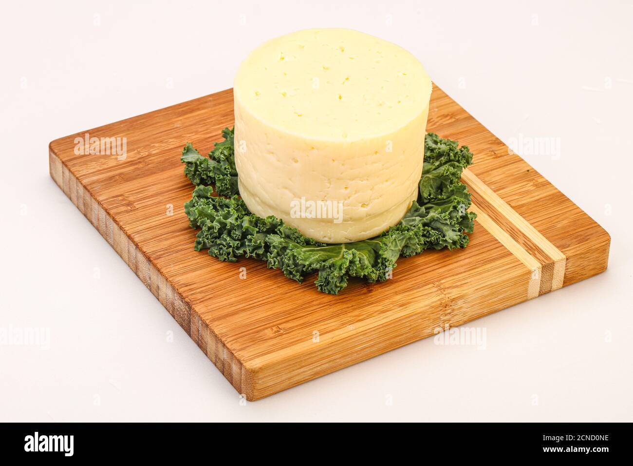Yellow round dairy soft cheese piece Stock Photo - Alamy