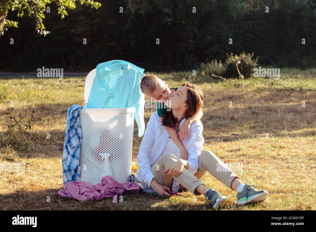 son kissing mom on break from household chores Stock Photo - Alamy