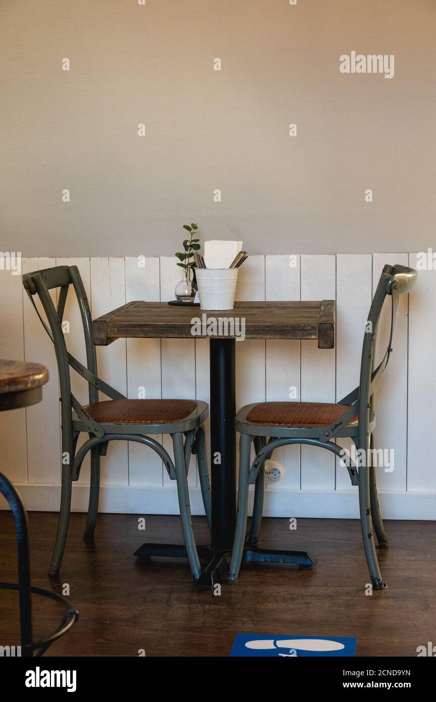 Two empty chairs at a rustic cafe table with no people Stock Photo - Alamy