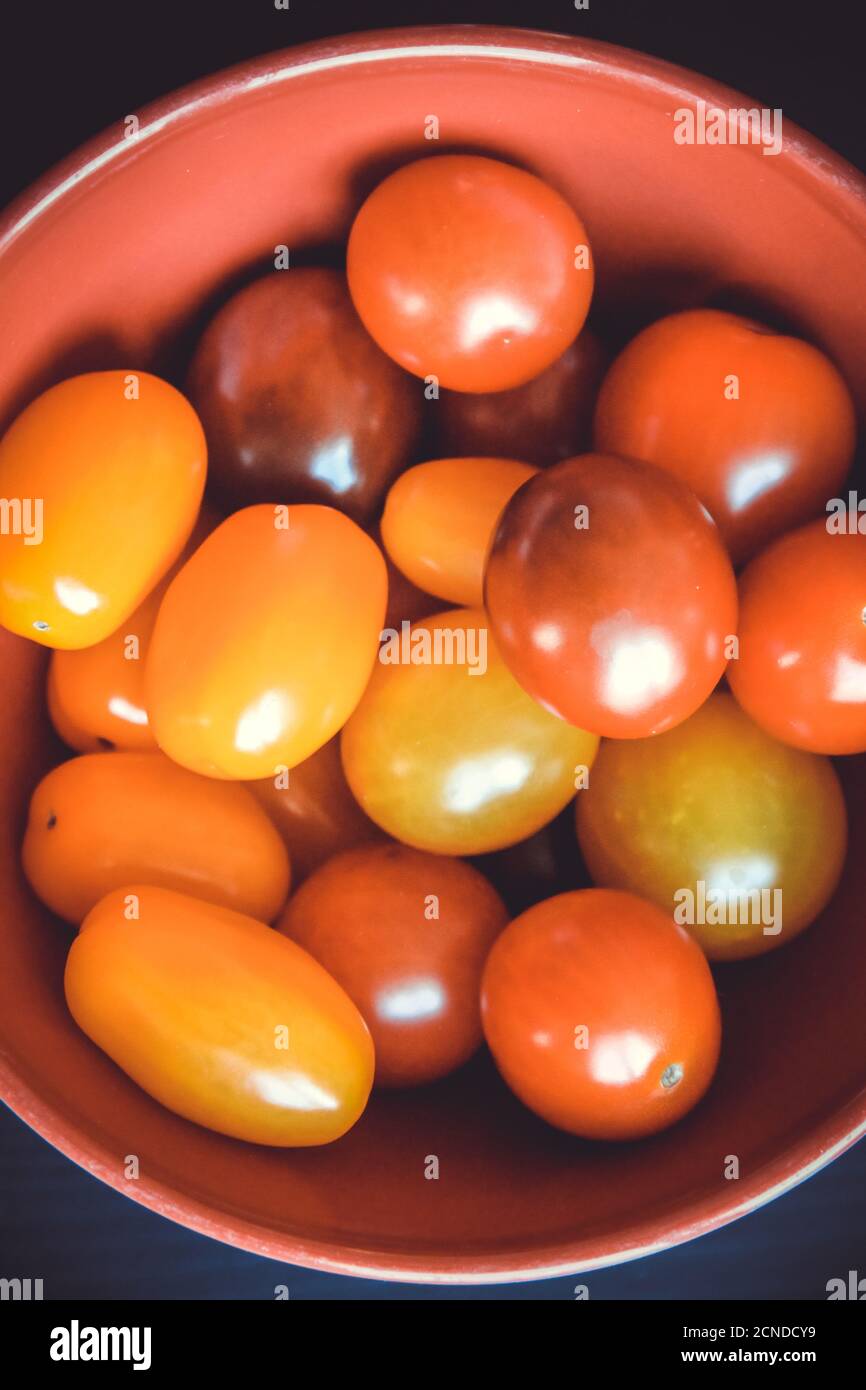 Colorful cocktail tomatoes in a bowl. Top view Stock Photo - Alamy