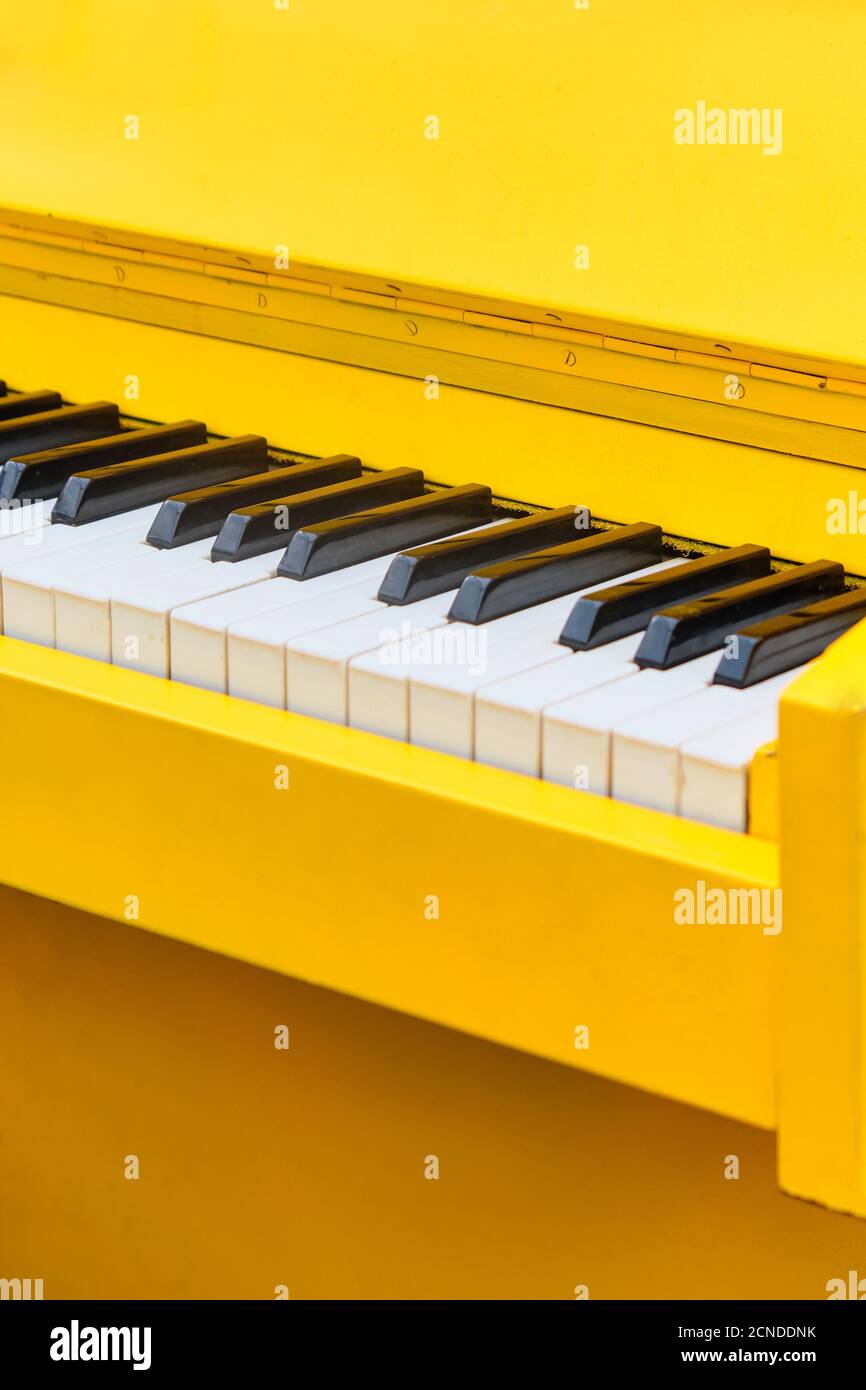 Vintage musical instrument yellow piano close up Stock Photo - Alamy