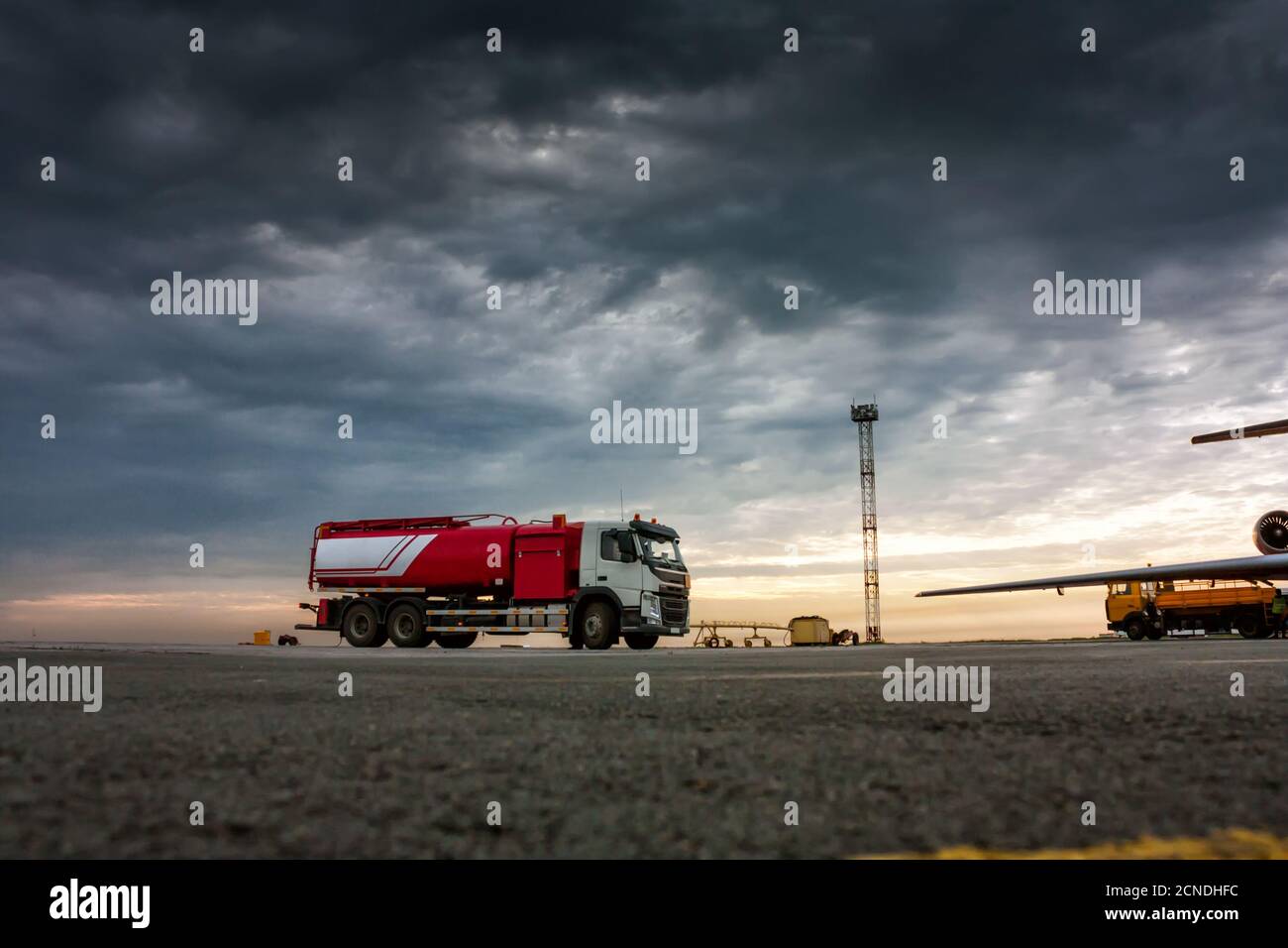 Aircraft fueler on the cloudy morning airport apron Stock Photo - Alamy