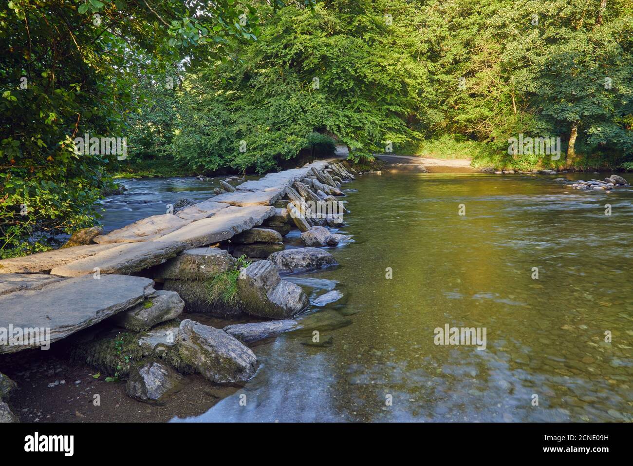 The prehistoric slab stone bridge, Tarr Steps, crossing the River Barle ...