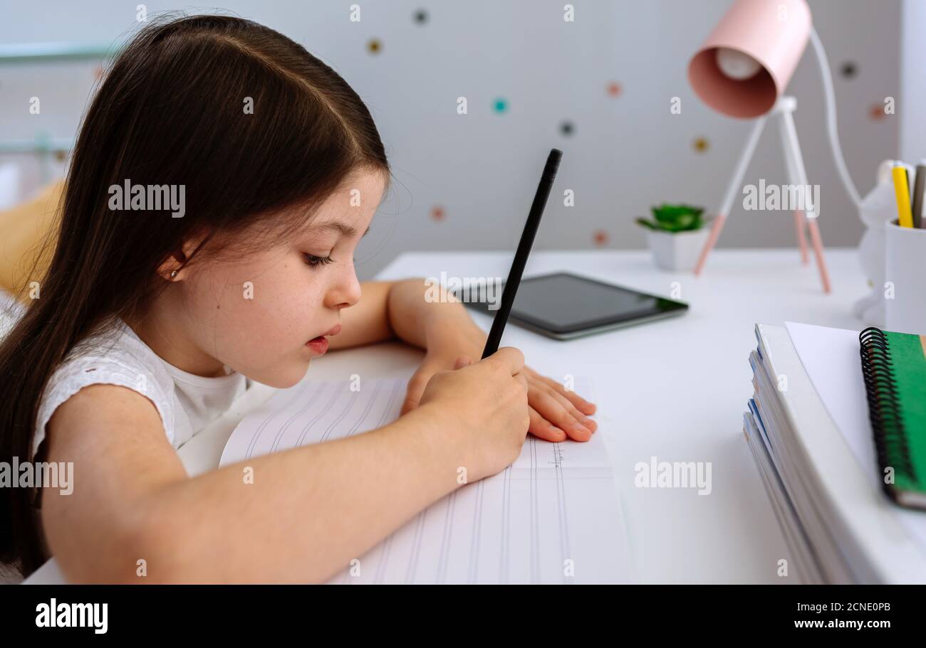 Girl doing homework in her bedroom Stock Photo - Alamy