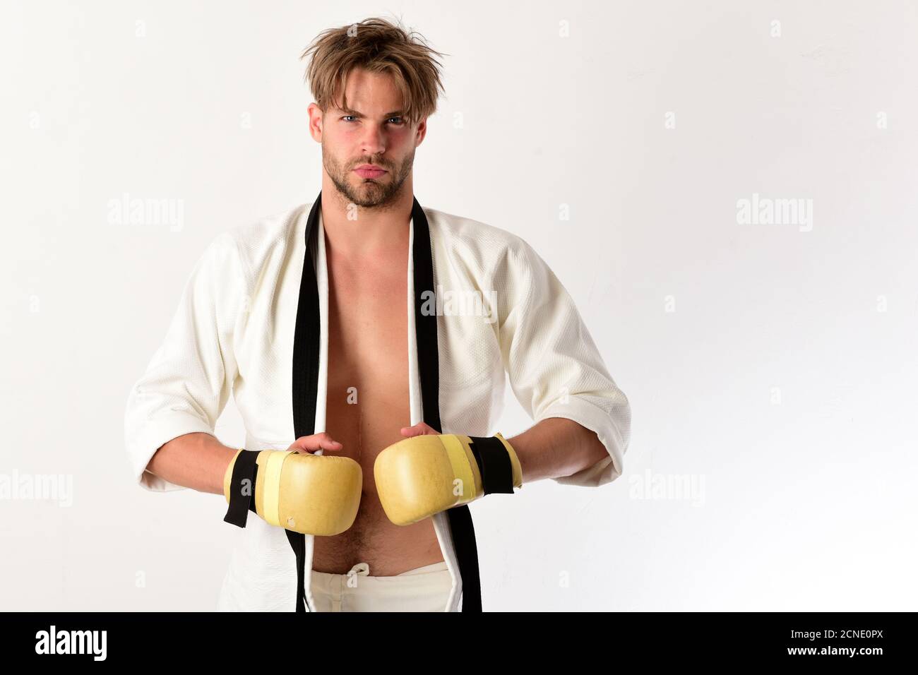 Handsome young muscular sportsman with golden boxing gloves isolated on ...
