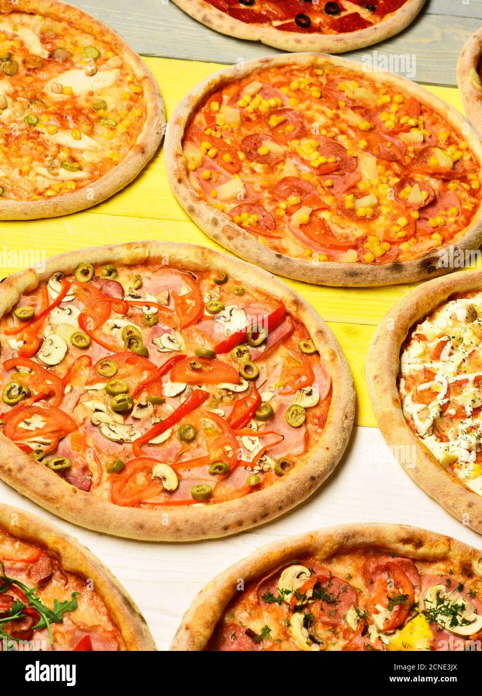Pizza circles with meat, mushrooms, tomatoes and cheese on light ...