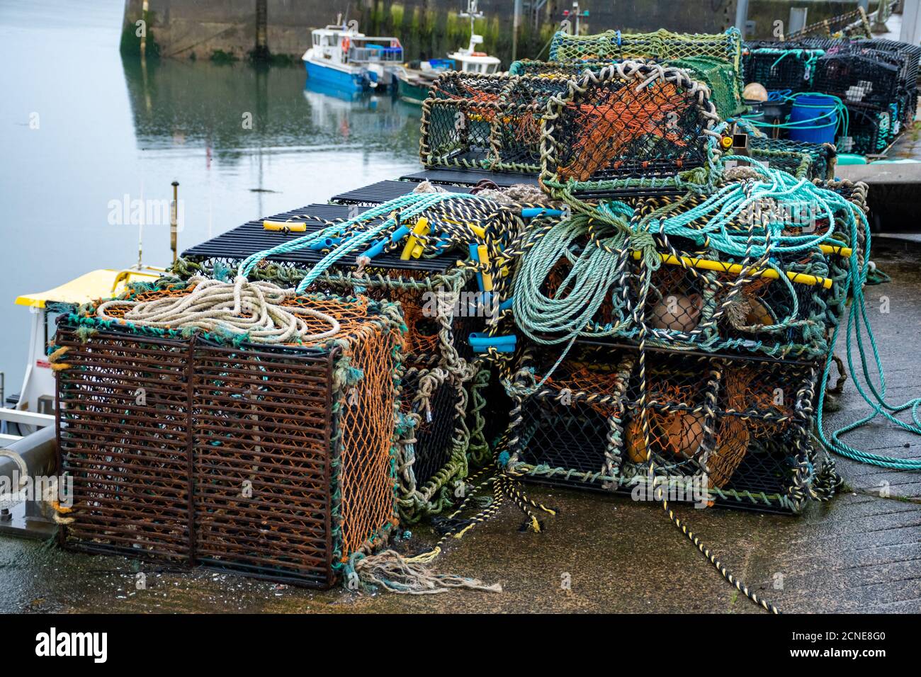 Commercial fishing nets and ropes on the dock by the water Stock Photo ...