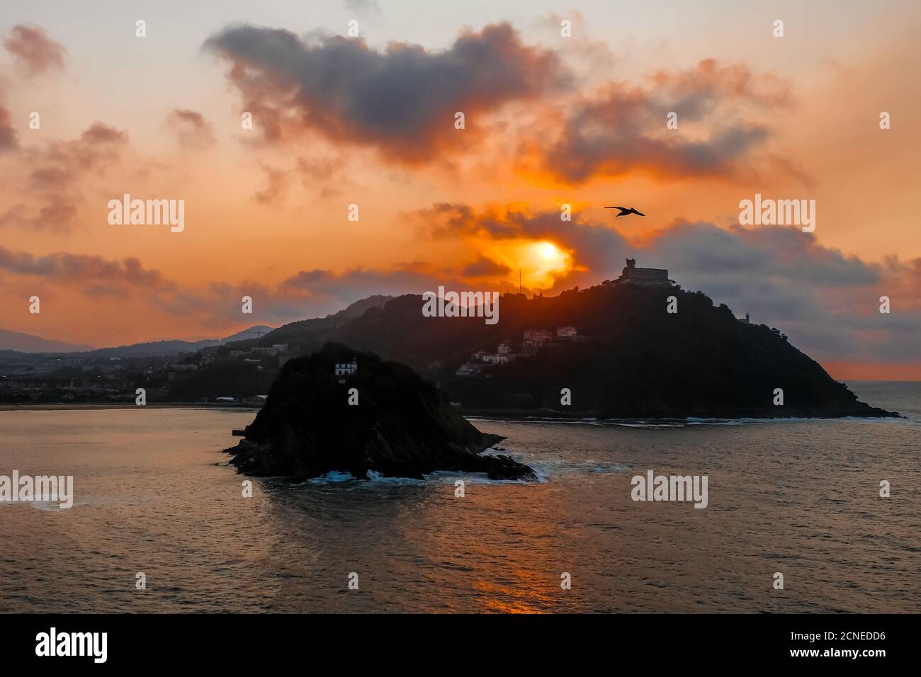 Sunset on the island of San Clara and Mount Igueldo in Donostia San ...
