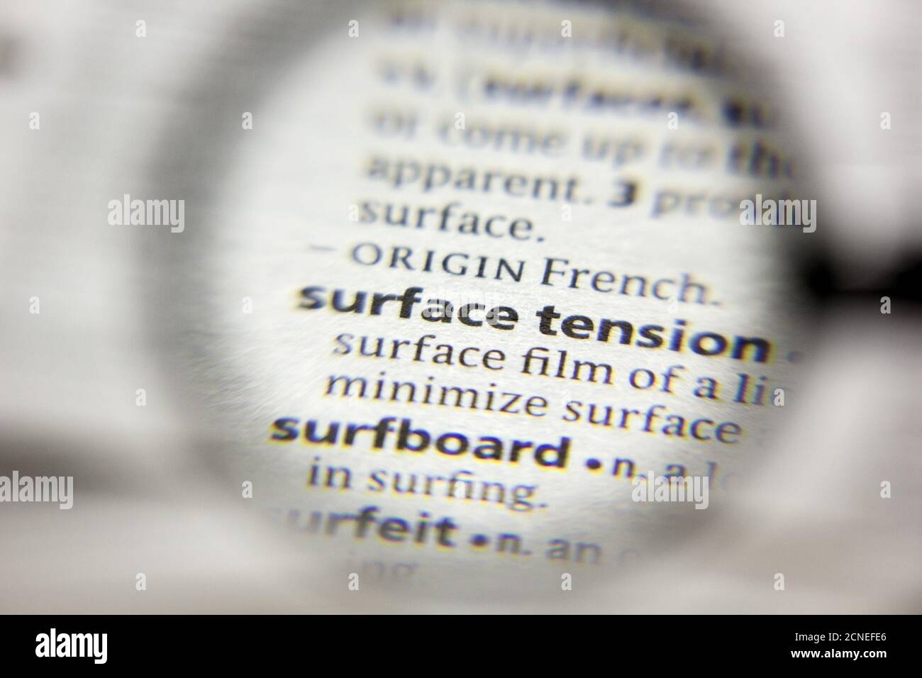 The word or phrase Surface tension in a dictionary Stock Photo - Alamy