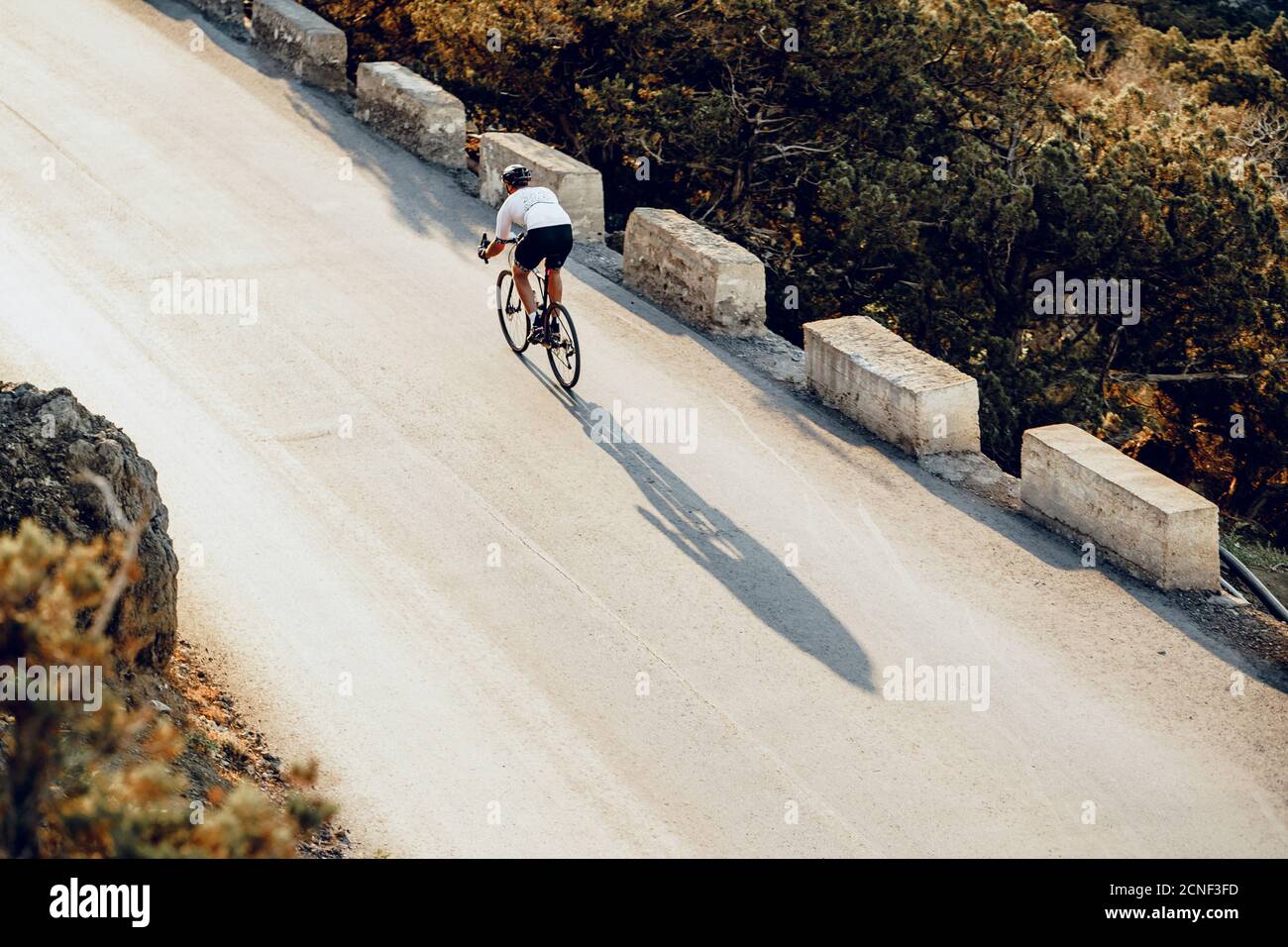 Cyclist riding on his bicycle at coastal road Stock Photo - Alamy