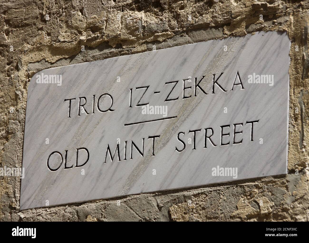 Carved street sign for Old Mint Street, Triq Iz-Zekka on a wall in ...