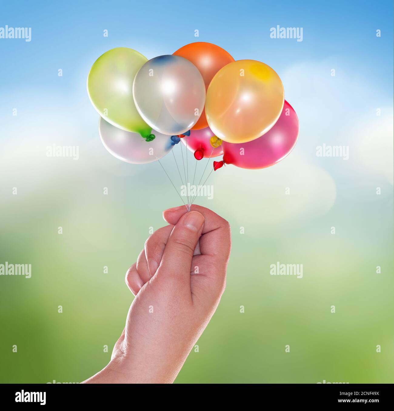 Hand with balloons Stock Photo - Alamy